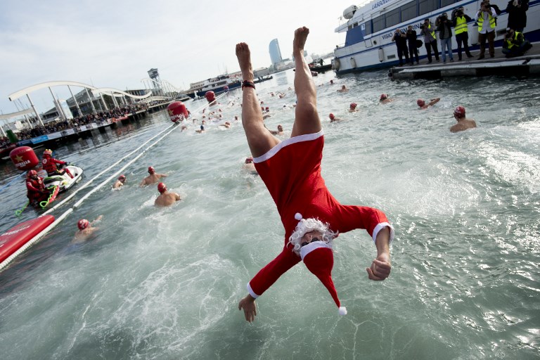 IN PICS: Santa-clad swimmers brace cold for annual Christmas swim in ...
